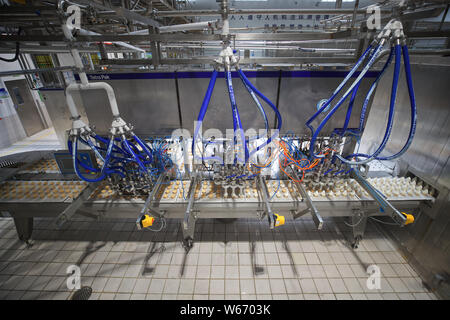 Yili torch ice creams are being produced on the assembly line at a ...