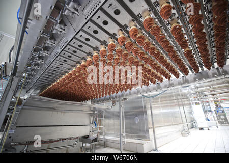 Yili torch ice creams are being produced on the assembly line at a ...