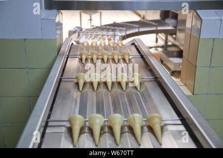 Yili torch ice creams are being produced on the assembly line at a ...