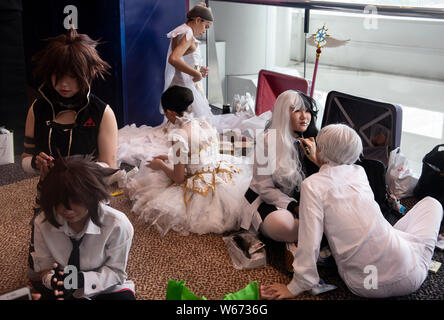 Cosplayers get dressed and make-up done during the Ani-com and E-Sports ...