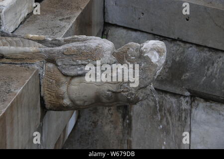 Rainwater flows from a dragon-shaped drainage gutter the Palace Museum ...