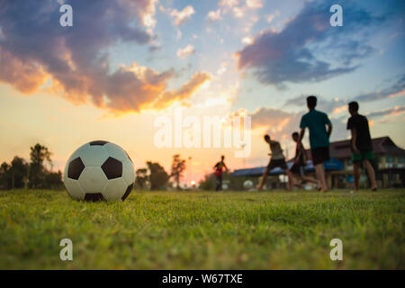 Silhouette action sport of kids having fun playing soccer football for ...