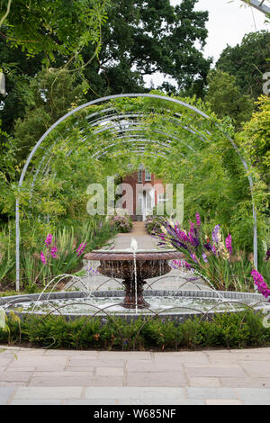 Water feature and wisteria archway at RHS Wisley Gardens, Surrey, UK ...