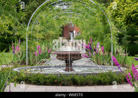 Water feature and wisteria archway at RHS Wisley Gardens, Surrey, UK ...