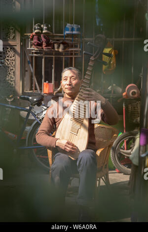 --FILE--Chinese craftsman Li Zhaolin carves Pipa, a four-stringed ...