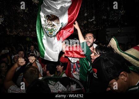 Fans shout and wave flags to celebrate after Russia defeated Saudi ...