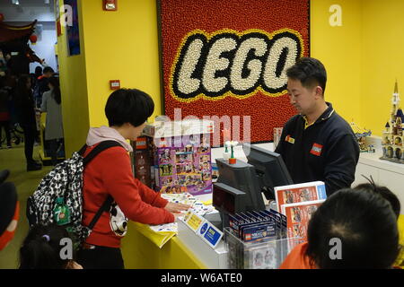 --FILE--Customers and employees are pictured at a Lego store at the ...