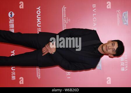 Taiwanese actor Zhang Zhen poses as he arrives on the red carpet for ...