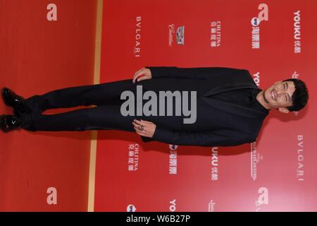 Taiwanese actor Zhang Zhen poses as he arrives on the red carpet for ...
