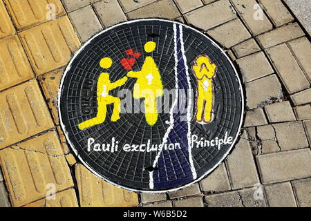 A manhole cover is decorated with special cartoon graffiti ...