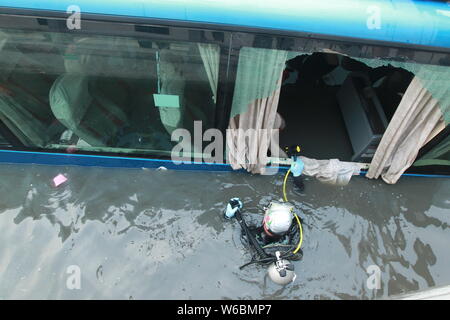 A member of rescue team from Zhengzhou Red Cross conducts an underwater ...