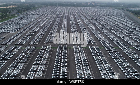 Aerial view of massive vehicles filling a parking lot in rows in ...