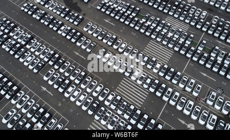Aerial view of massive vehicles filling a parking lot in rows in ...