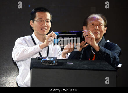 Cambricon Technology CEO Chen Tianshi shows the Cambricon MLU100 cloud ...