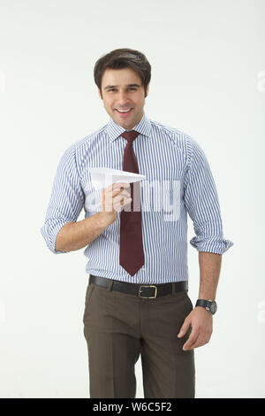 Businessman playing with paper airplane Stock Photo - Alamy