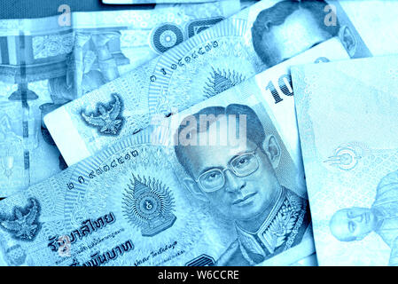 Various banknotes thai baht close up. Money background blue color toned ...