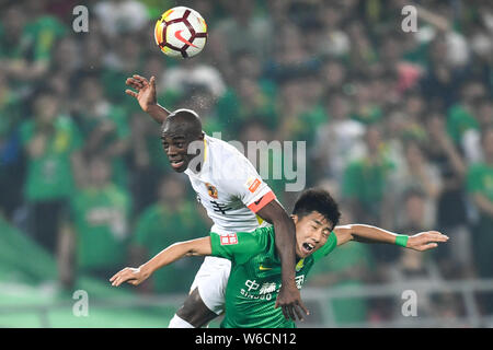 Festus Baise of Guizhou Hengfeng heads the ball against Jiangsu Suning ...