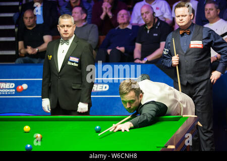 Jamie Jones of Wales plays a shot against John Higgins of Scotland ...