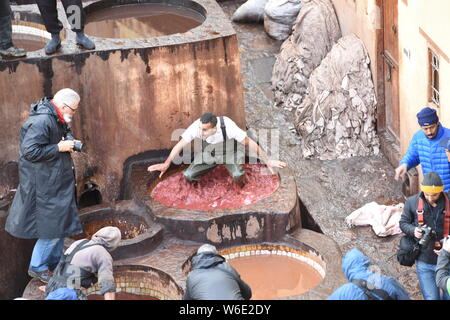 --FILE--Workers soak leather in the pools of honeycomb vats containing ...