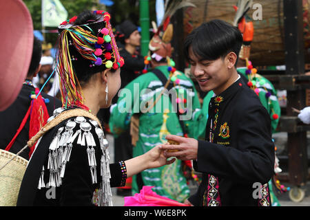 Chinese people of Jingpo ethnic group wearing traditional costumes and ...