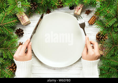 Female hand holds ceramic Christmas ball hanging on ribbon. Christmas ...
