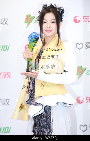 Japanese singer Mai Kuraki poses with her trophy during the 25th ...
