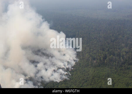 An aerial photo shows a forest fire, continues to spread in Ofunato ...