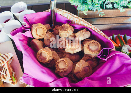 Homemade baked uchpuchmak (samsa) with meat and potato on a wooden ...