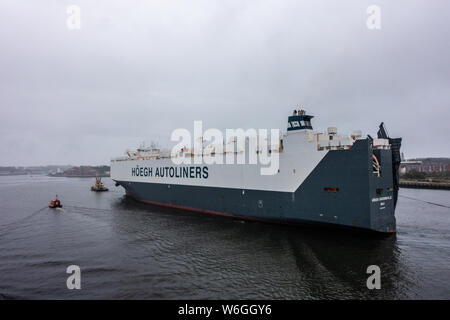 Pilot boat takes an autoliner vessel for exporting cars, out into the ...