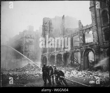 Firemen at work in a bomb-damaged street in London after a Saturday ...
