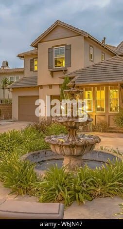 House with a fountain in a beautiful garden near the forest, in early ...