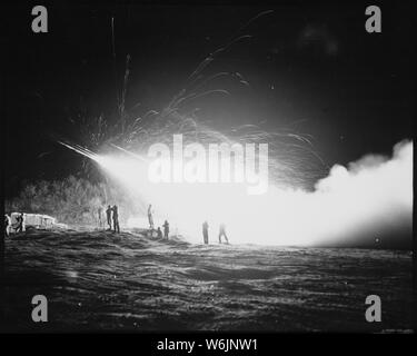 Night view of the First Rocket Battery, 11th Marine Regiment, firing a ...