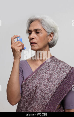 Old woman using asthma inhaler. Asthma Treatment, Elderly Person Stock ...