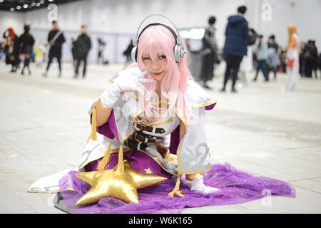 A Chinese coser dressed in cosplay costume poses during an animation ...