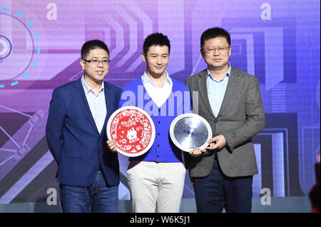 Chinese actor Huang Xiaoming, center, and his actress wife Angelababy ...