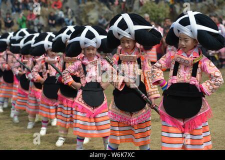Chinese women of Miao ethnic group wearing traditional costumes show a ...