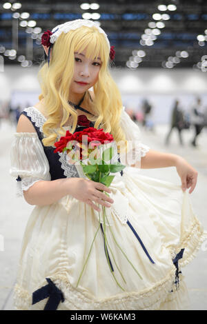 A Chinese coser dressed in cosplay costume poses during an animation ...