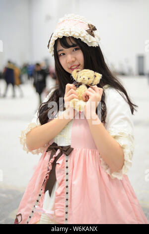 A Chinese coser dressed in cosplay costume poses during an animation ...