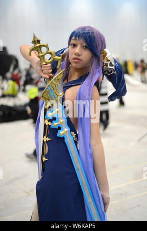 A Chinese coser dressed in cosplay costume poses during an animation ...