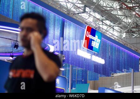 --FILE--A logo of UnionPay is pictured on its headquarters building in ...