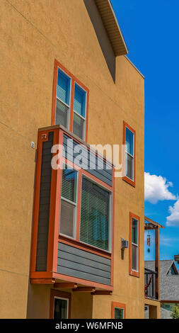 Residential building with a window protruding from the exterior wall. A ...