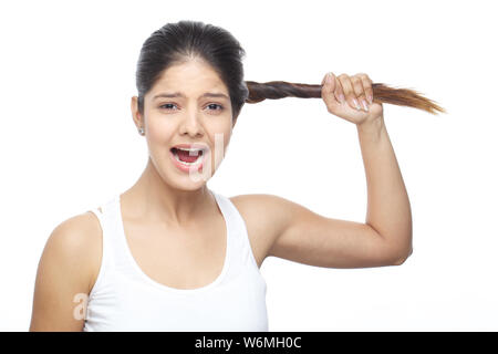 Furious woman pulling her hair Stock Photo - Alamy
