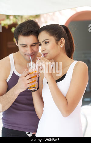 Couple sharing fruit and orange juice breakfast in bed Stock Photo - Alamy