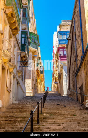 Maltese narrow street with long staircase in Valletta, Malta Stock ...