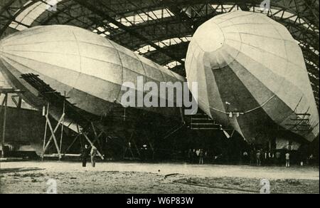 A photograph of two Zeppelins in a hangar. Referred to as "German ...