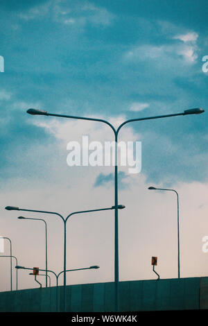 A Row of Lamps in the Road at Sunset Stock Photo - Alamy