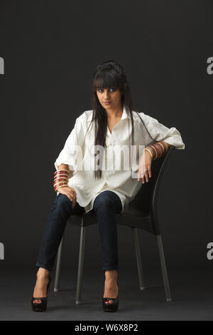 Indian bride sitting on chair in traditional wearing for marriage ...