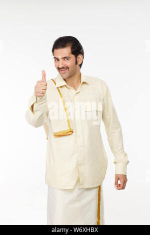 South Indian man standing Thumbs Up Stock Photo - Alamy