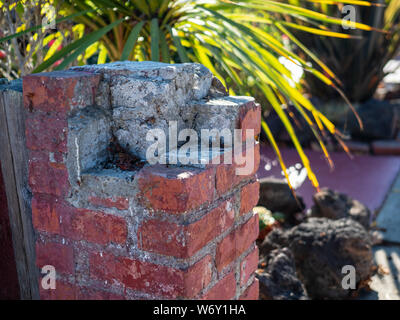 Brick grey broken masonry wall with cement white concrete damaged ...