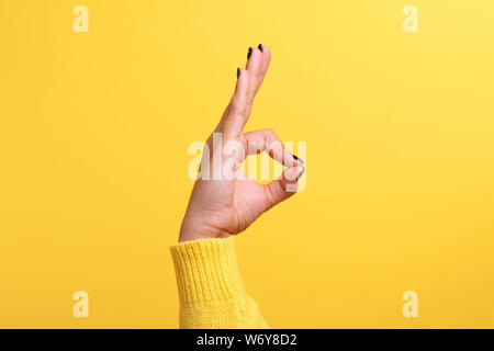 hand ok sign over trend yellow background Stock Photo - Alamy